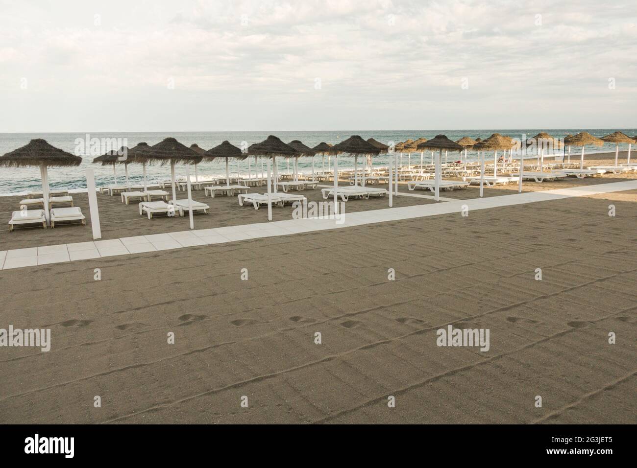 Empty spanish Beach with parasols.on a clouded day, Andalusia, Spain ...
