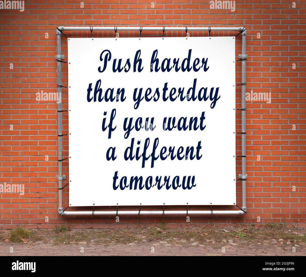 Large banner with inspirational quote on a brick wall Stock Photo - Alamy