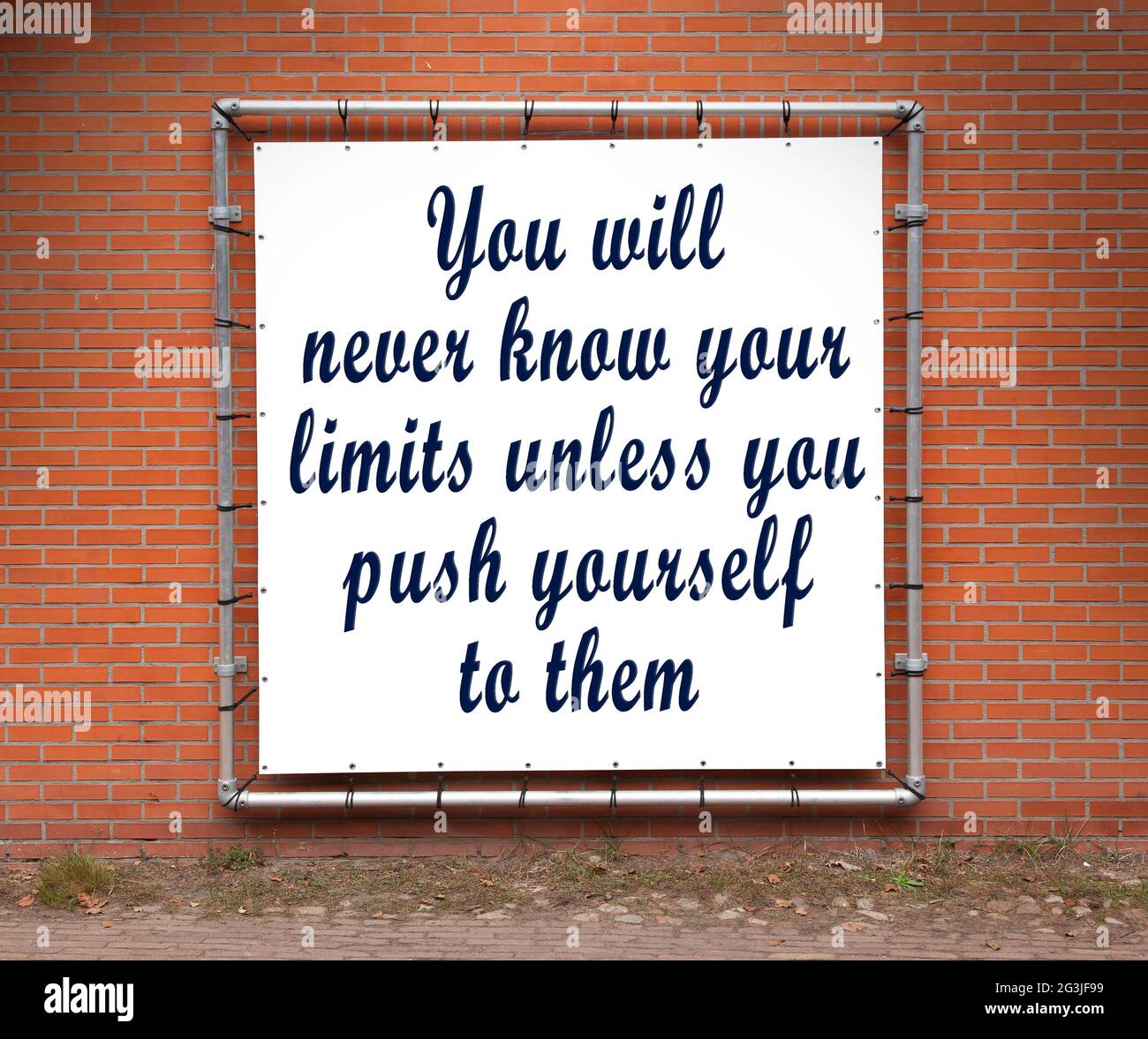 Large banner with inspirational quote on a brick wall Stock Photo - Alamy