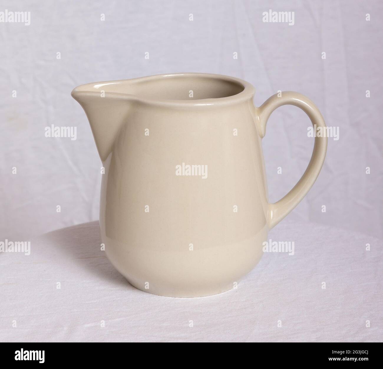 Milk jug isolated on white Stock Photo - Alamy