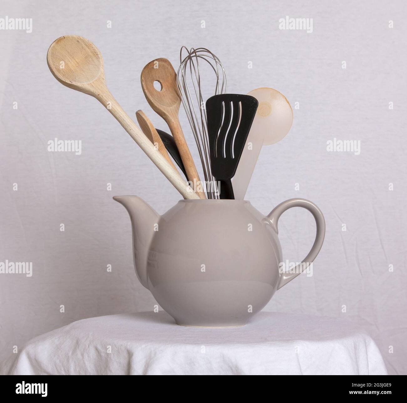 Old teapot filled with spoons Stock Photo - Alamy