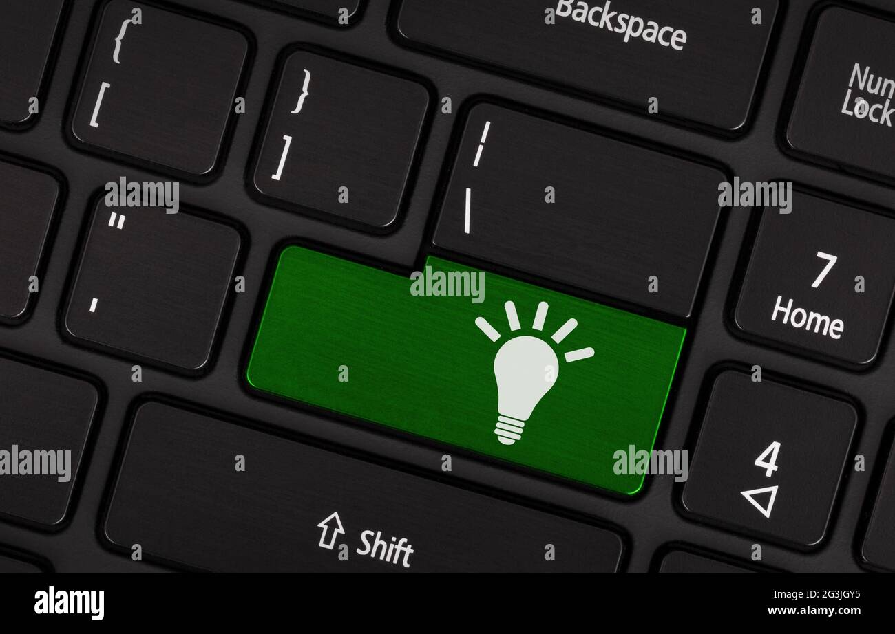 Laptop keyboard with light bulb symbol Stock Photo - Alamy