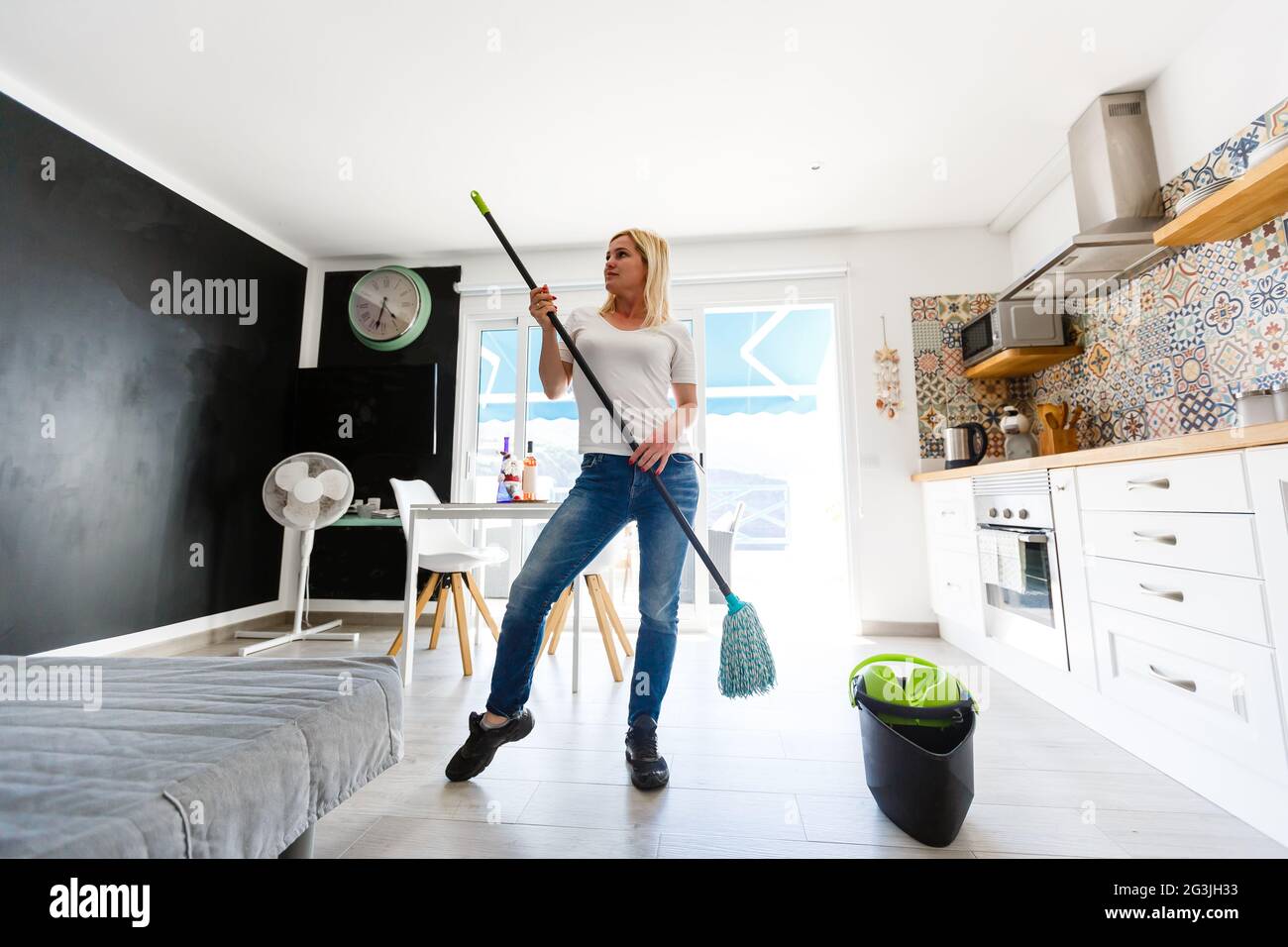 Cleaning concept. Young woman washing floor on the kitchen Stock Photo ...