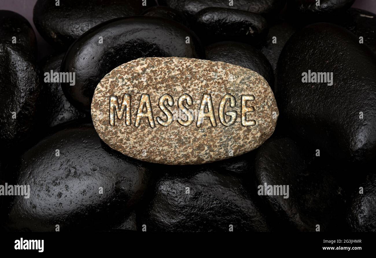 Massage word engraved on black and white stones Stock Photo - Alamy