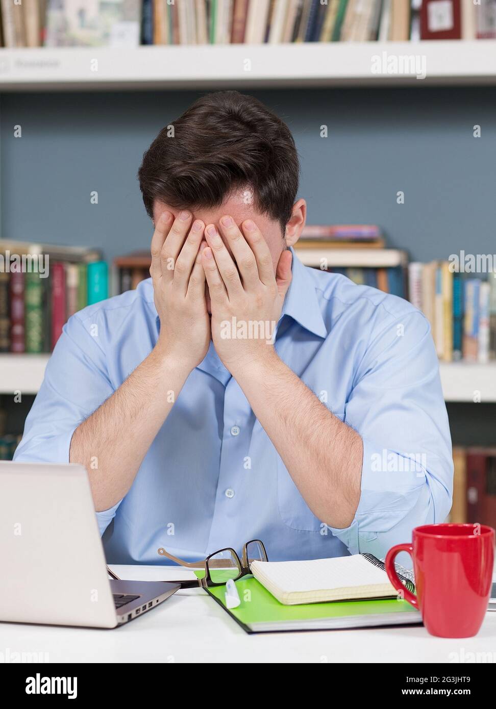 Sad student in library Stock Photo - Alamy