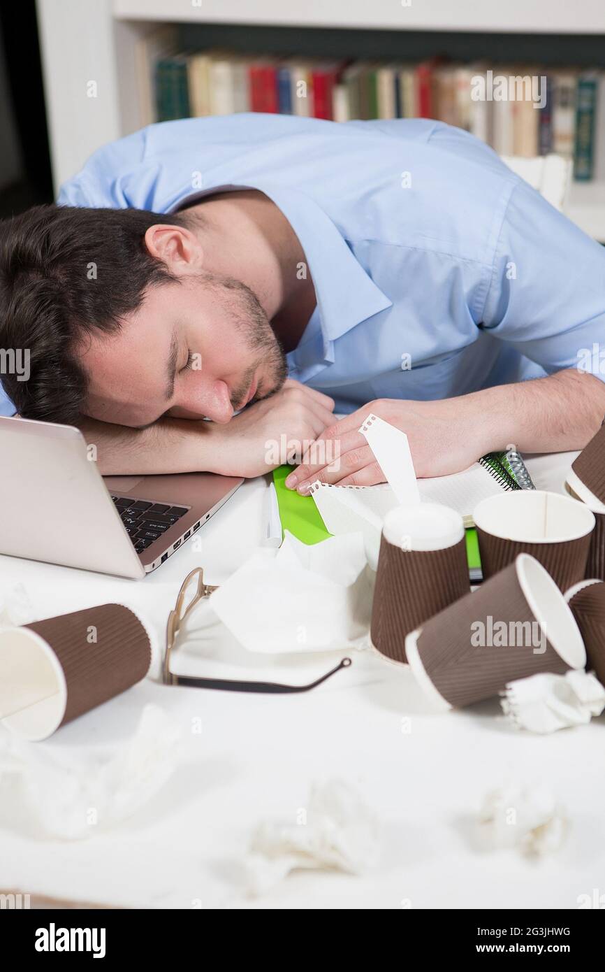 Tired student in library Stock Photo - Alamy