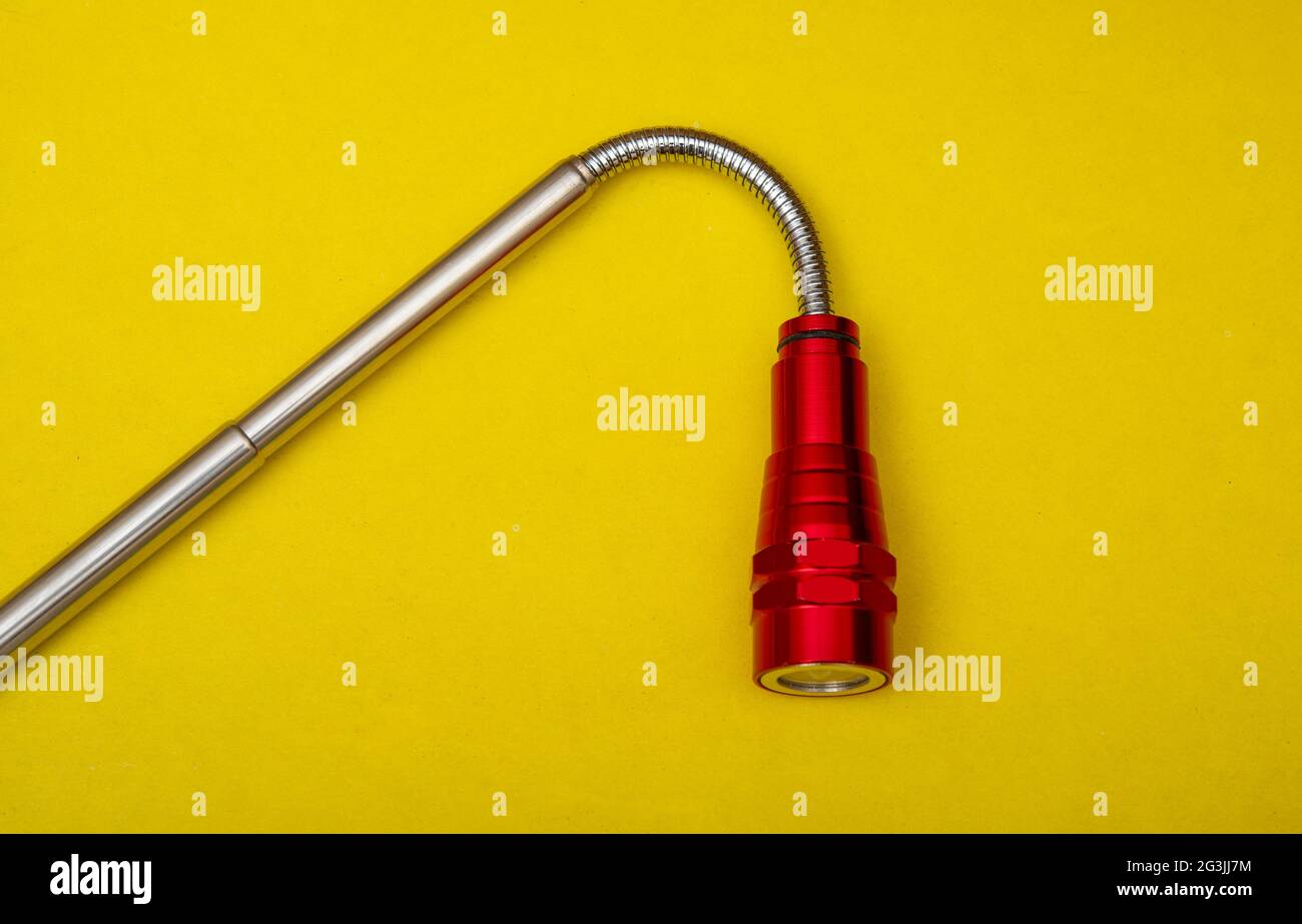 Folding portable torch light on yellow background Stock Photo - Alamy