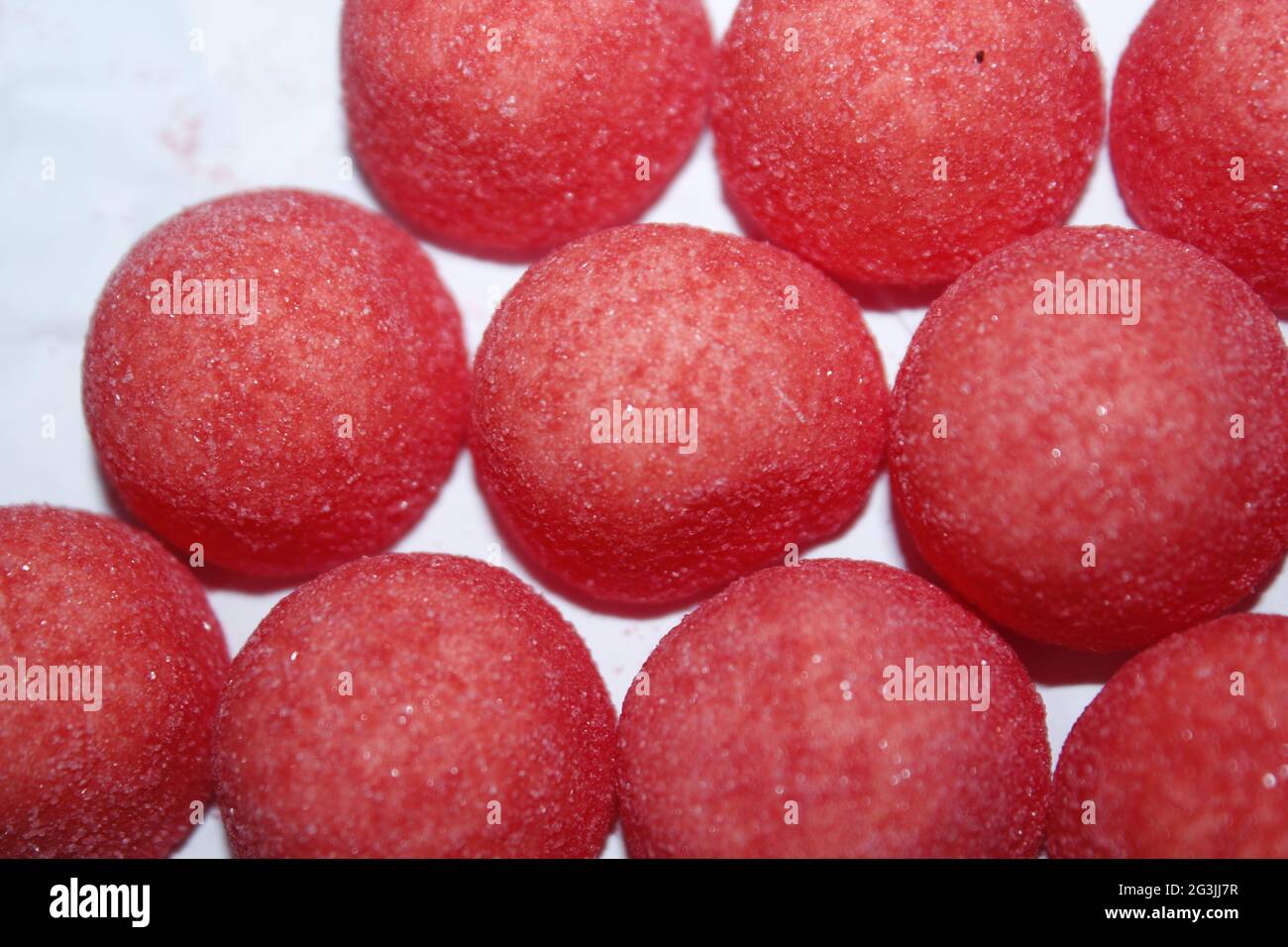 Red strawberry candies on white background Stock Photo - Alamy