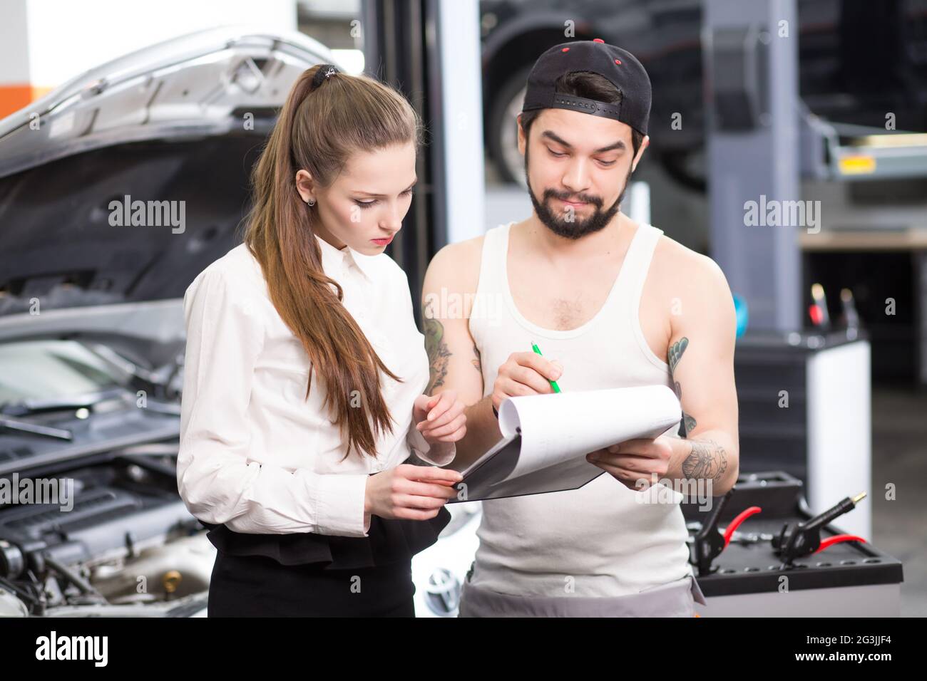 Customer woman and mechanic Stock Photo - Alamy