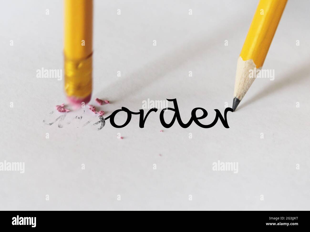 Eraser deleting the word Disorder Stock Photo - Alamy