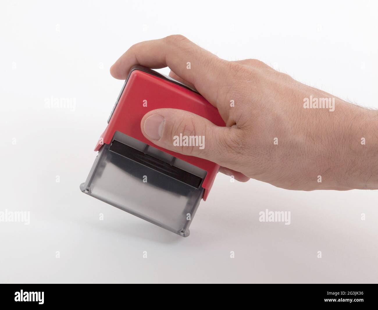 Plastic stamp in hand, isolated Stock Photo - Alamy