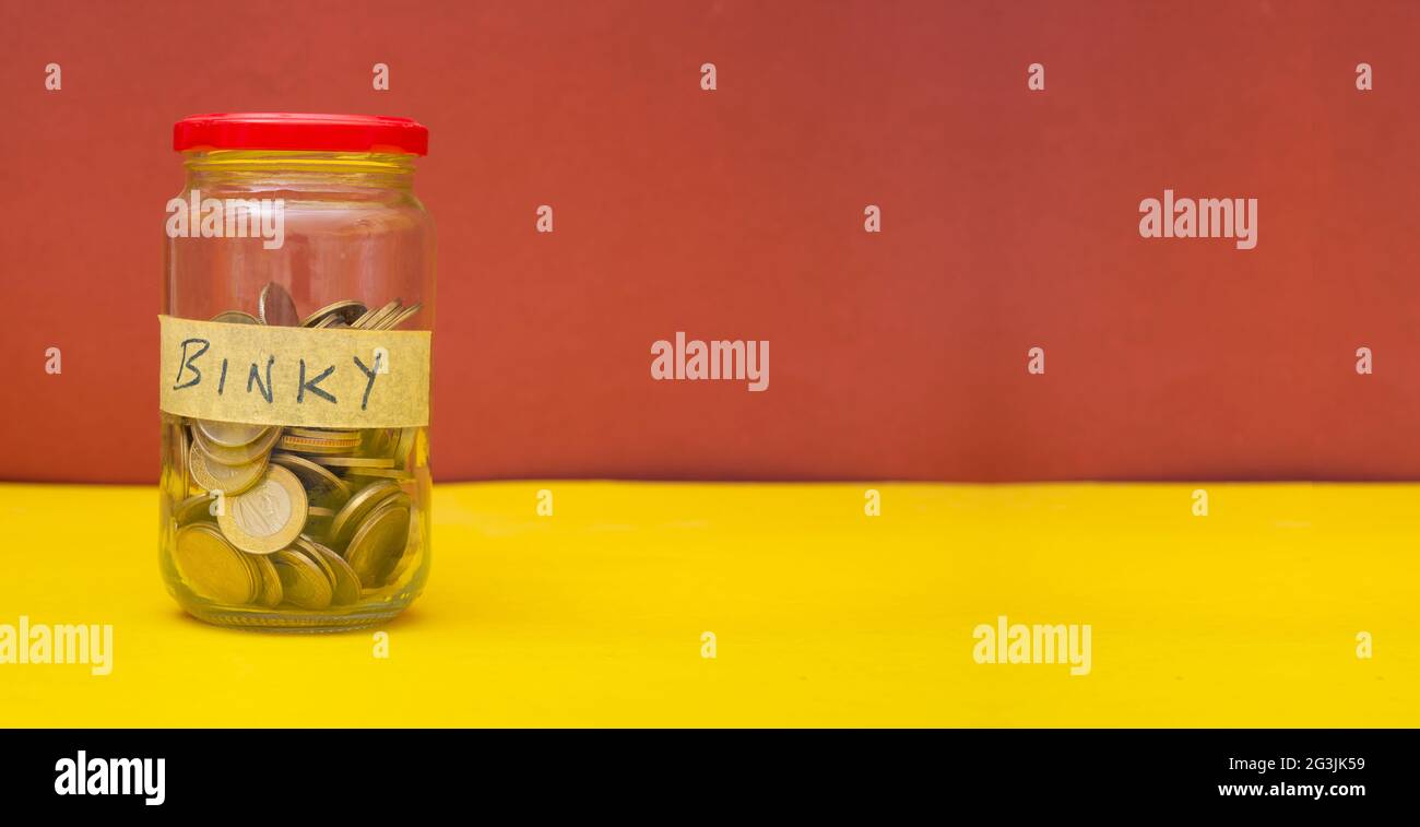 Binky box with coins showing save money concept Stock Photo - Alamy
