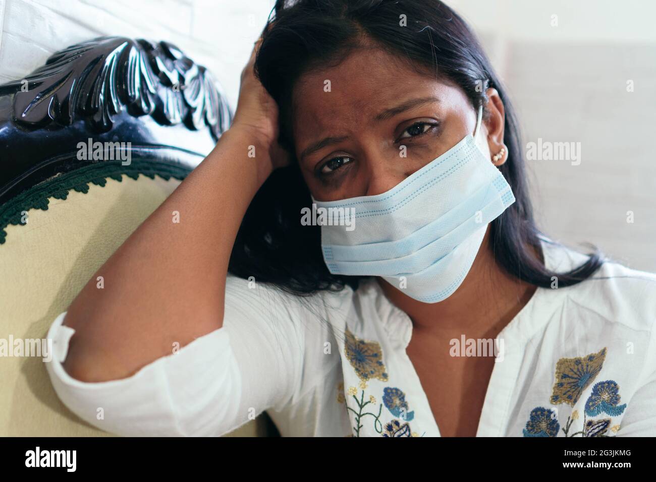 Crying woman with protective mask looking at the camera Stock Photo - Alamy