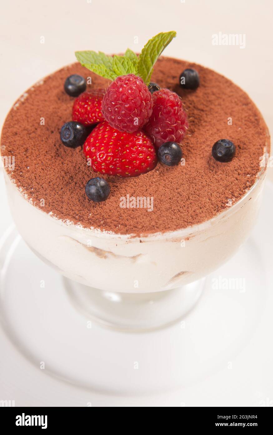 Tiramisu cake in glass with small fruits Stock Photo - Alamy