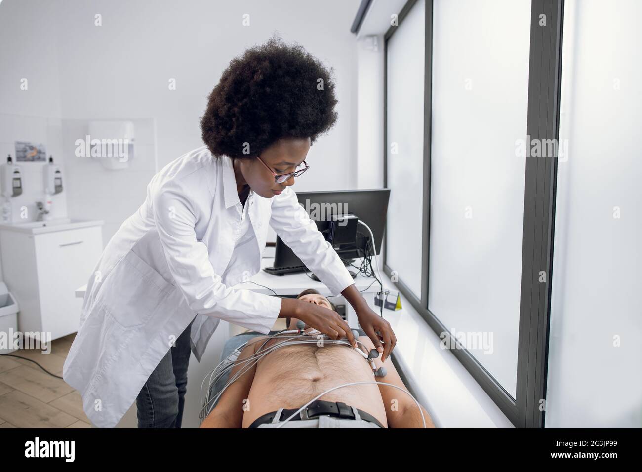 Medicine, health and heart check-up concept. Young afro-american woman ...