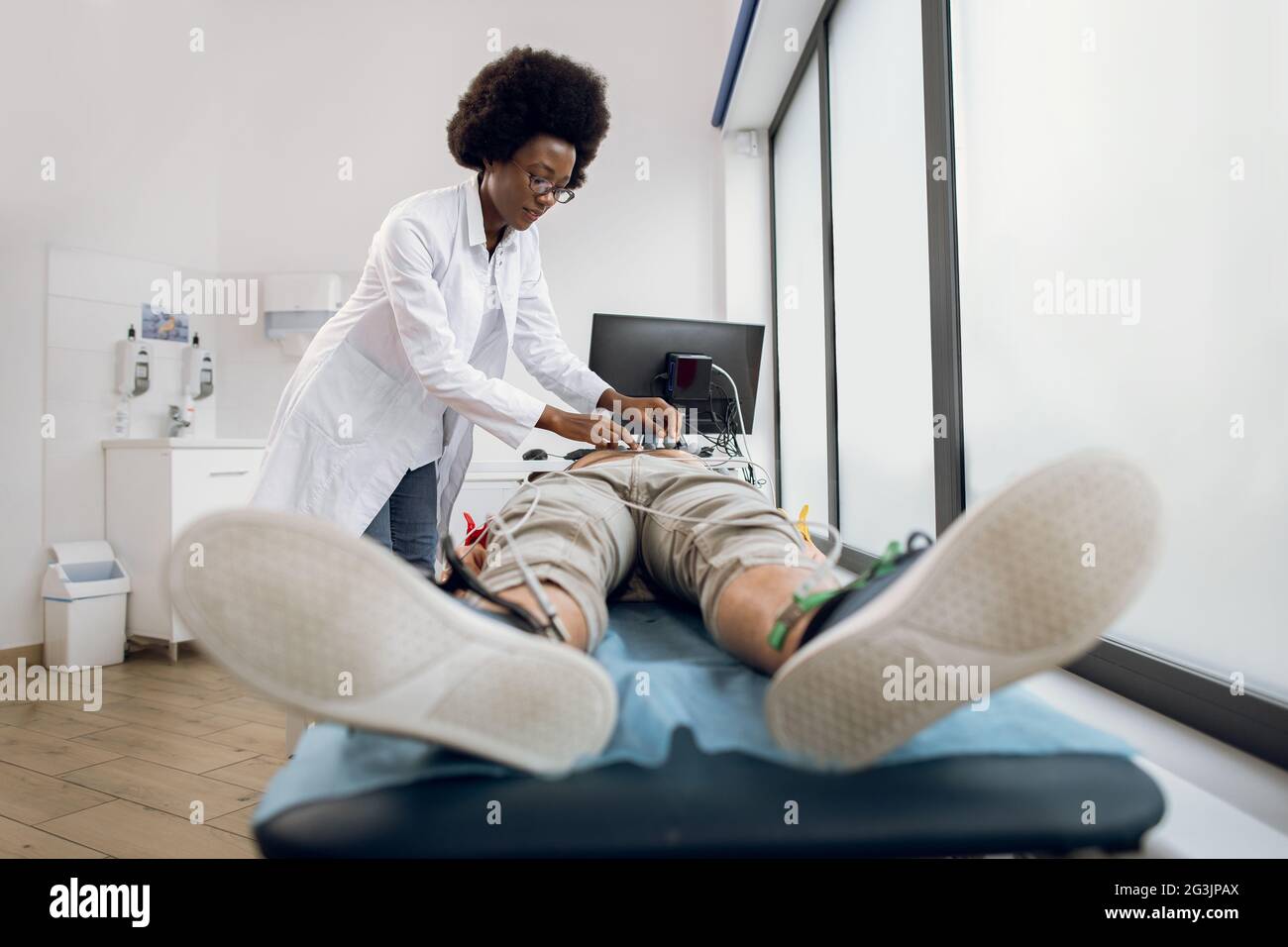 Heart electrocardiogram for young man patient. Young African American ...