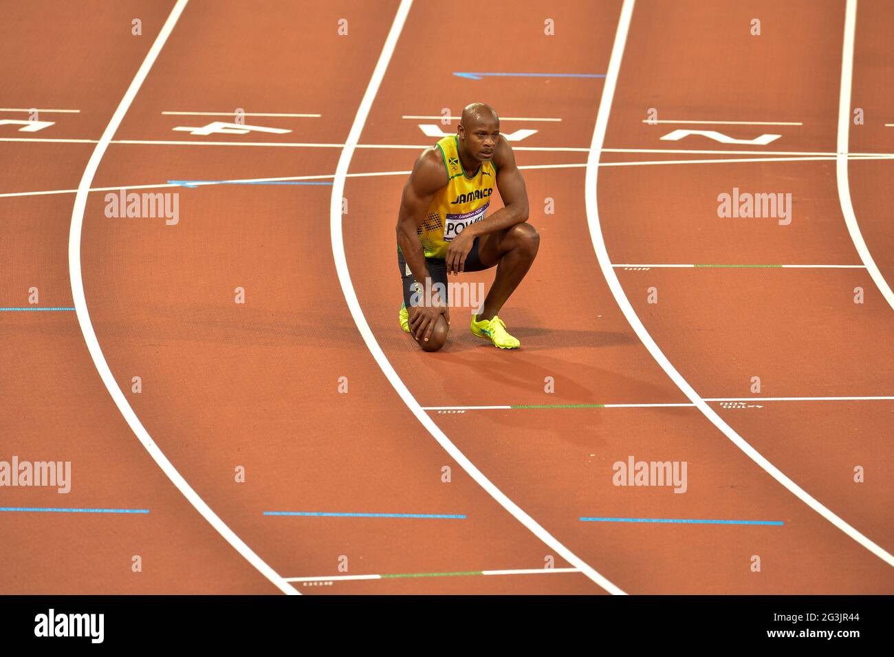 LONDON, ENGLAND - AUGUST 5, Asafa Powell of Jamaica sits dejected after ...