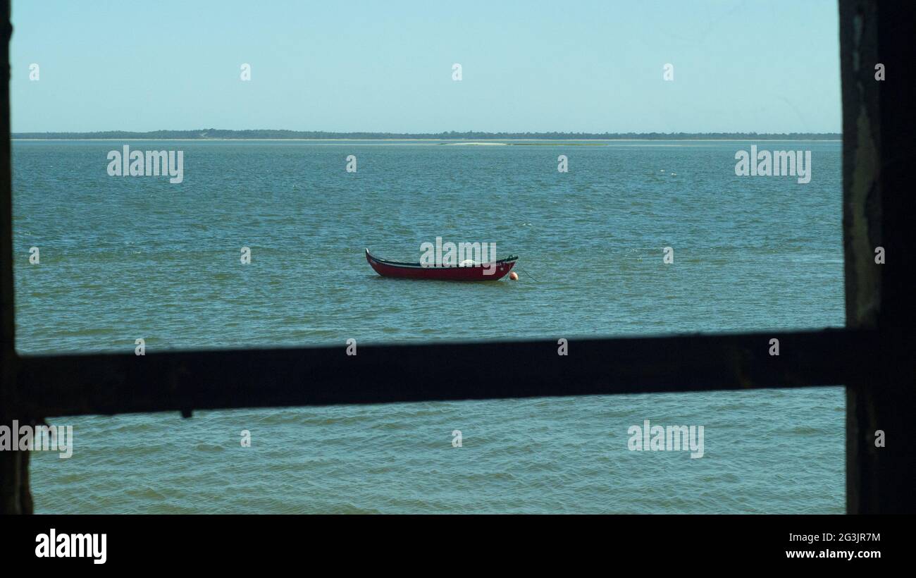 Boat near the shore, a warm sunny afternoon on the beach in Setubal ...