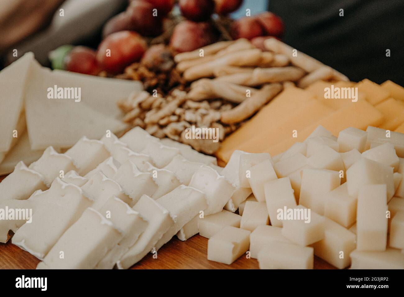 Closeup shot of sliced cheese on a charcuterie board Stock Photo - Alamy
