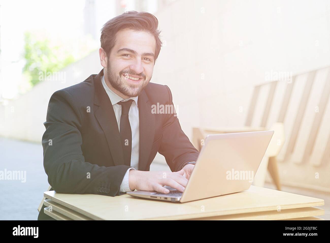 Modern businessman using laptop sitting hi-res stock photography and ...