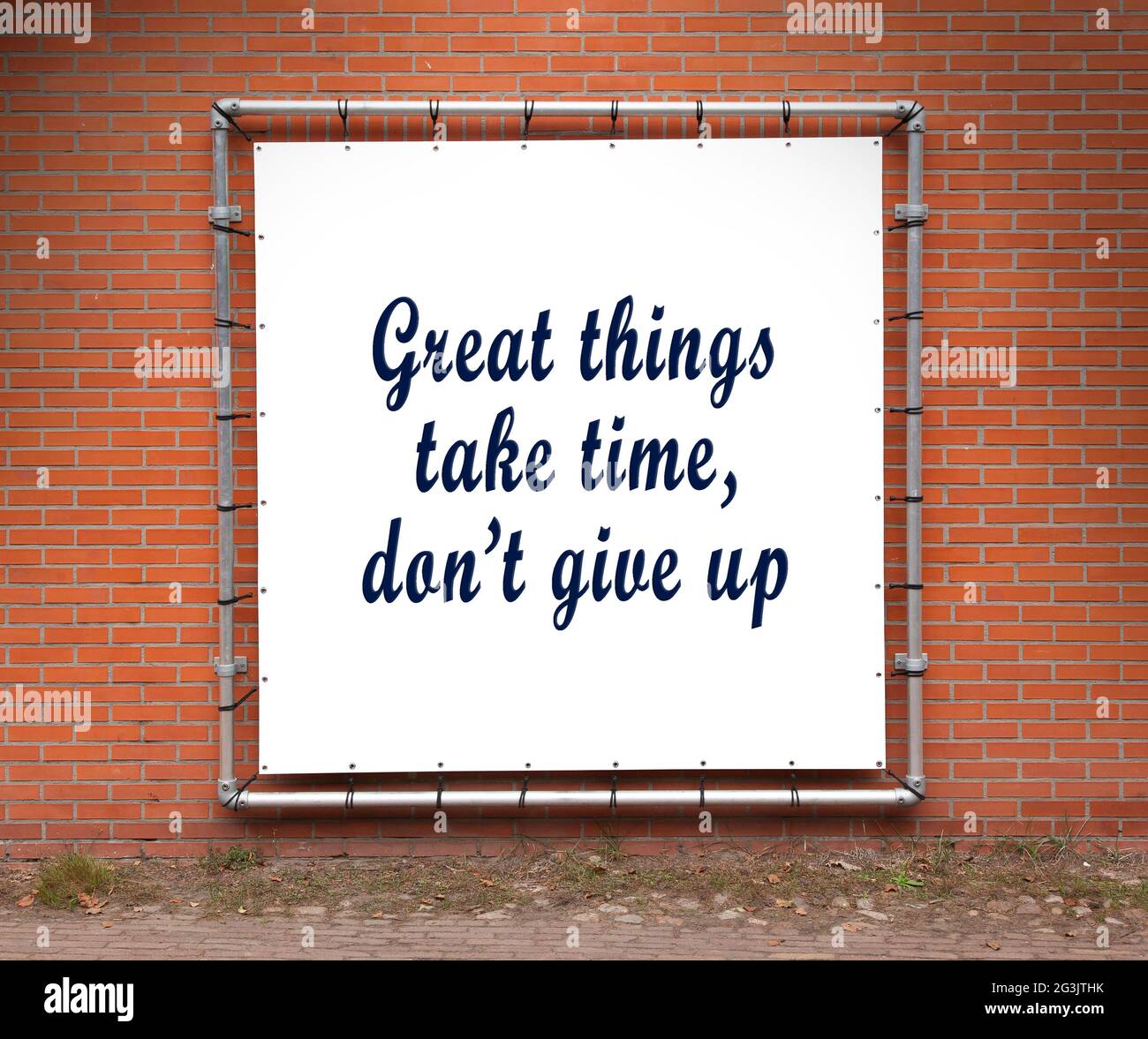 Large banner with inspirational quote on a brick wall Stock Photo - Alamy