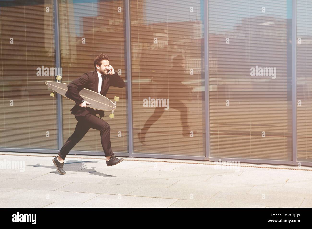Businessman running on street Stock Photo - Alamy