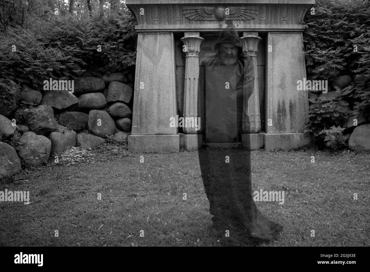 A ghost in front of a grave crypt. The ghost is wearing a black hooded ...