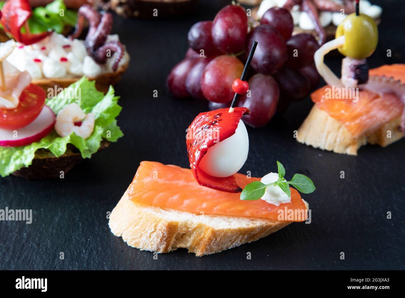 Traditional Spanish tapas sandwich made with quail egg, red pepper ...
