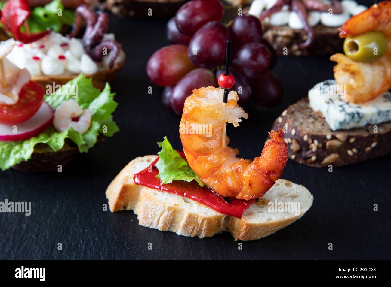 Traditional Spanish food - tapas sandwich consisting of shrimp, bread ...