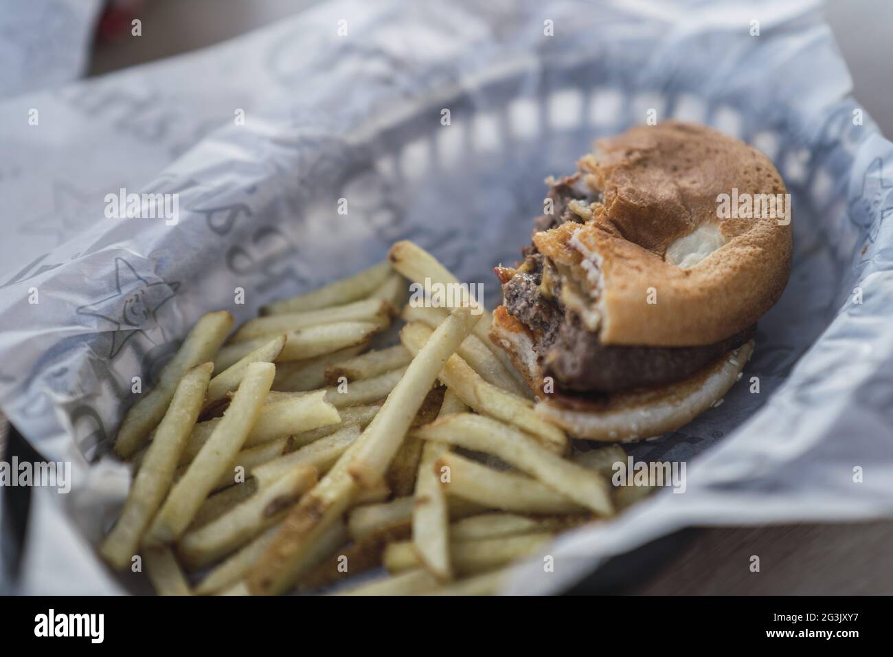 Closeup of a half eaten burger with fries in a fast food platter Stock ...