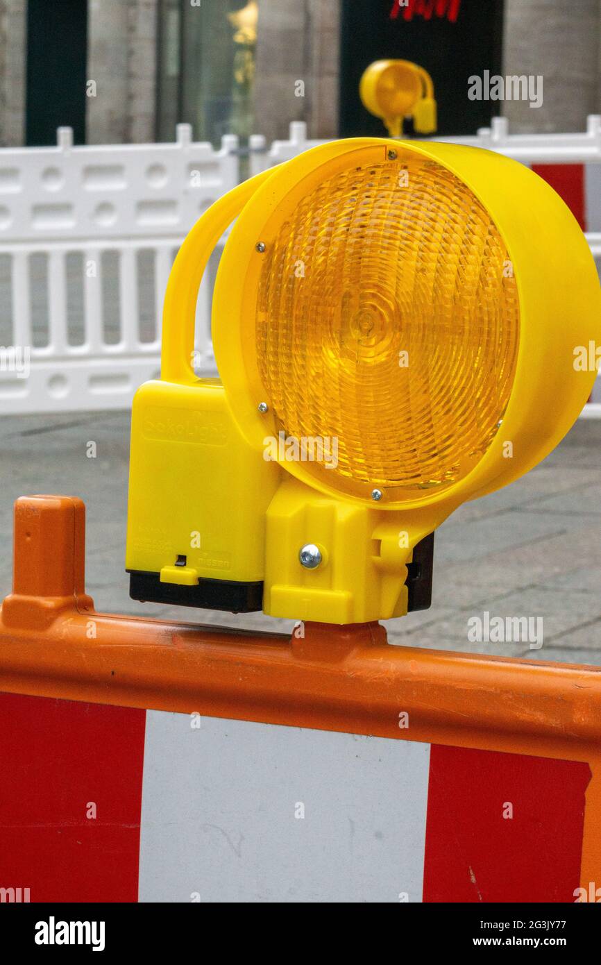 Vertical shot of a yellow warning headlight sign at a construction site ...