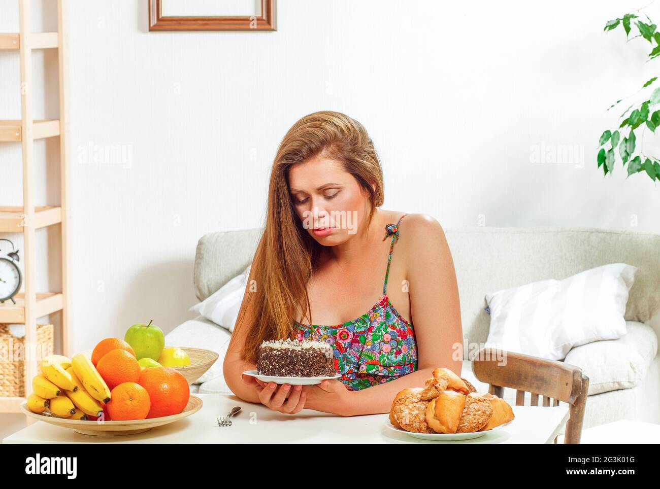 Fat woman sitting at table home Stock Photo - Alamy