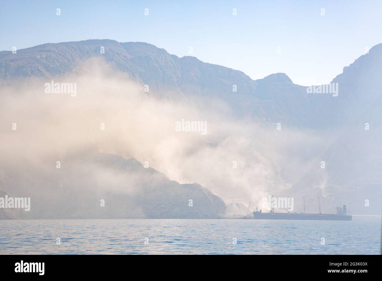 A ship being loaded with sand from nearby quarry, Khasab, Oman Stock ...
