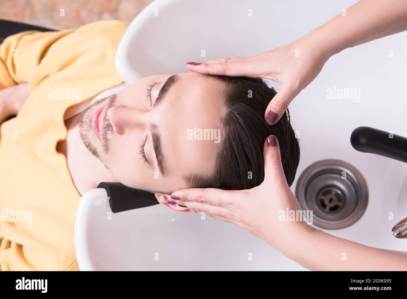 Handsome man in hairdressing saloon Stock Photo - Alamy