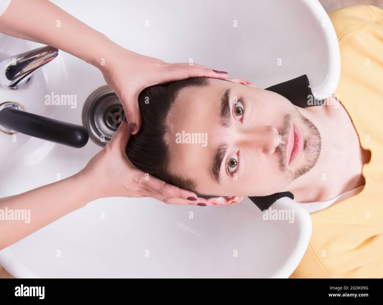 Handsome man in hairdressing saloon Stock Photo - Alamy