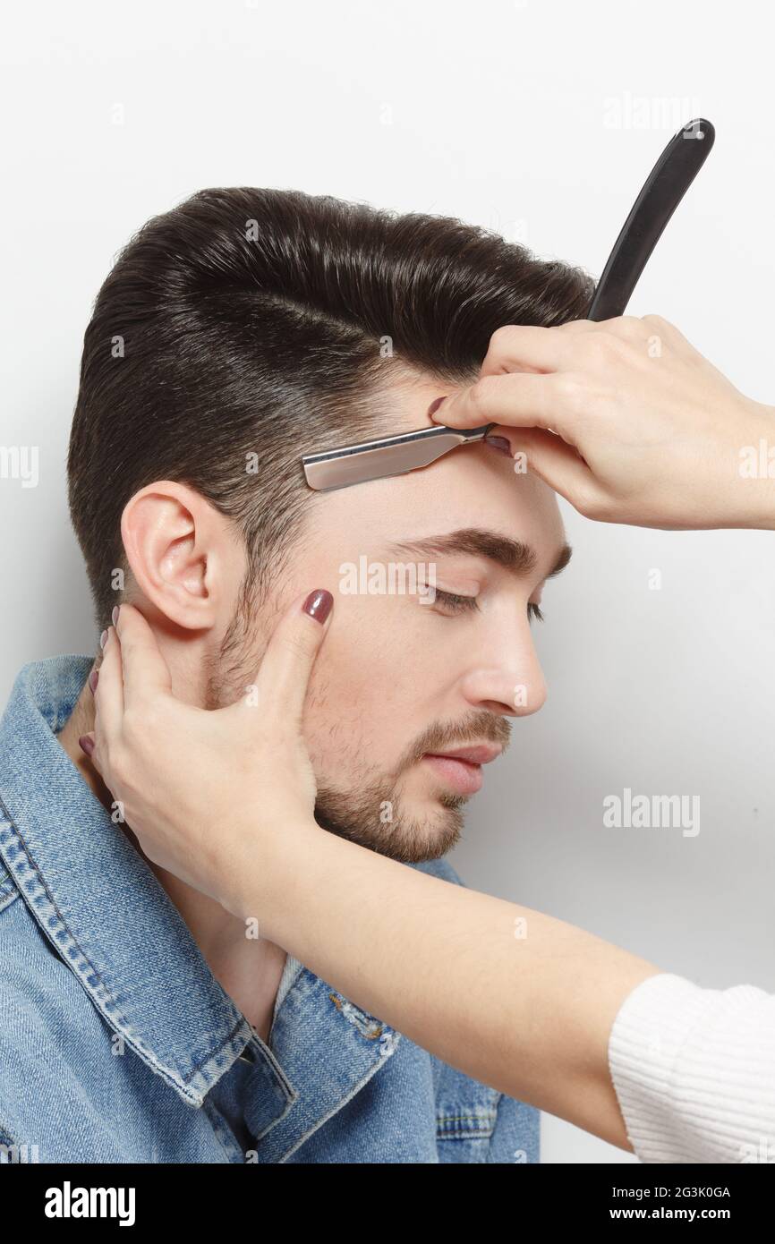 Handsome man having haircut Stock Photo - Alamy