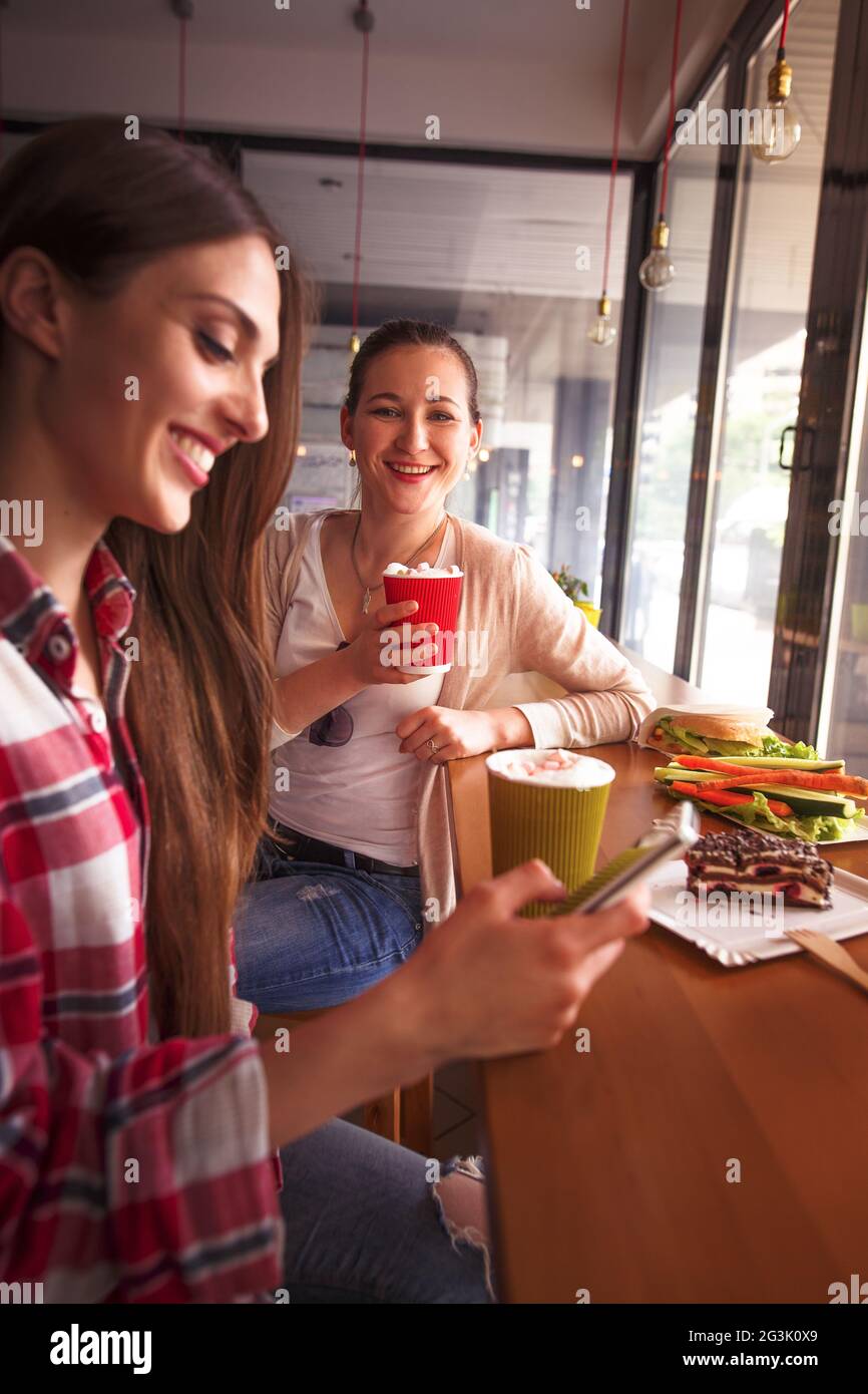 Best friends ladies in cafe Stock Photo - Alamy