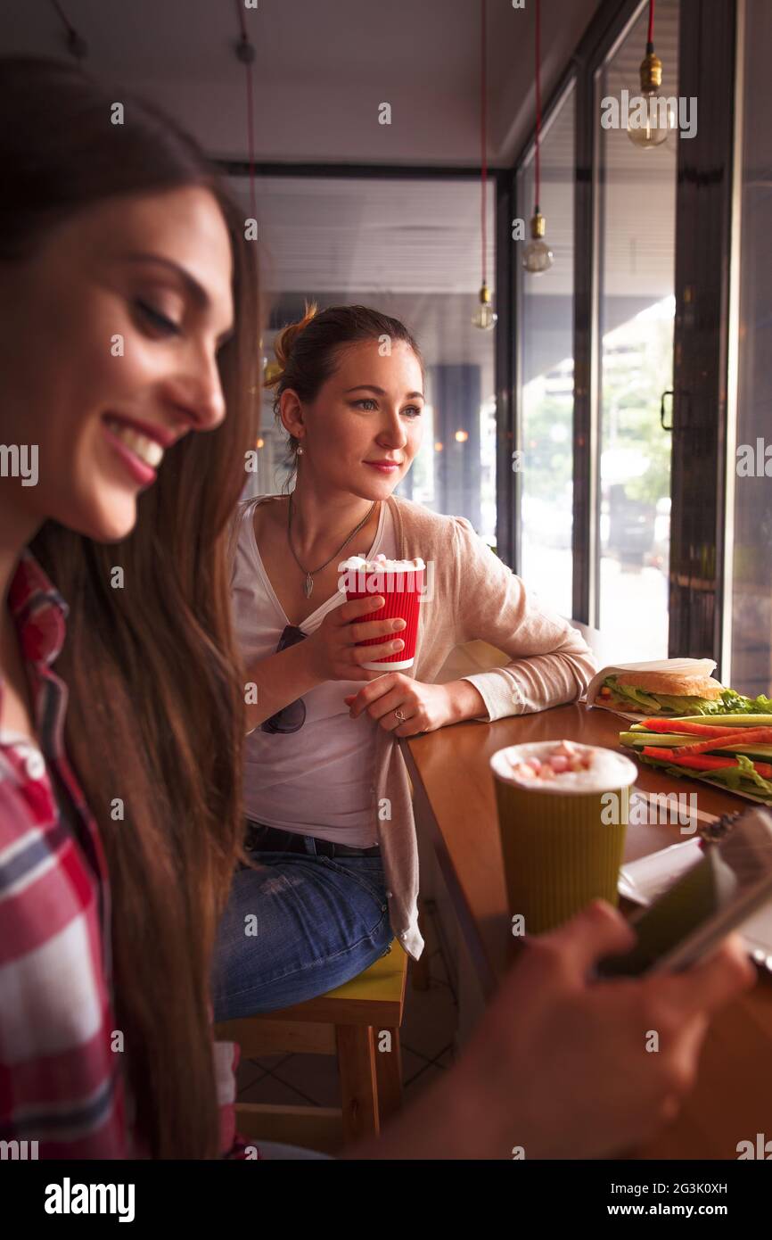 Best friends ladies in cafe Stock Photo - Alamy