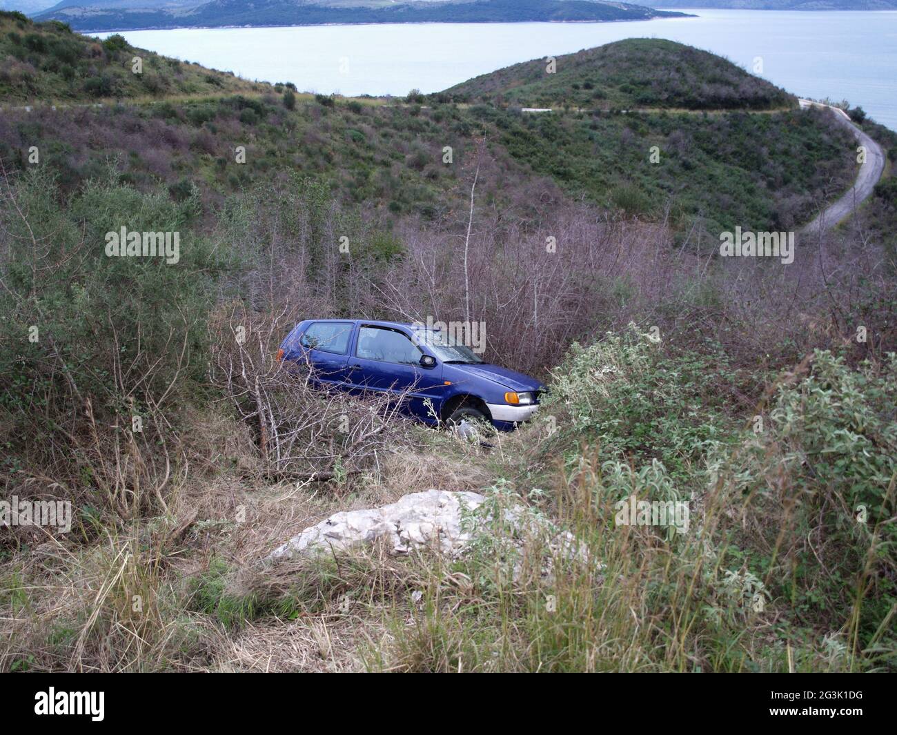 Crashed VW polo car which has left the dangerous winding mountain road ...