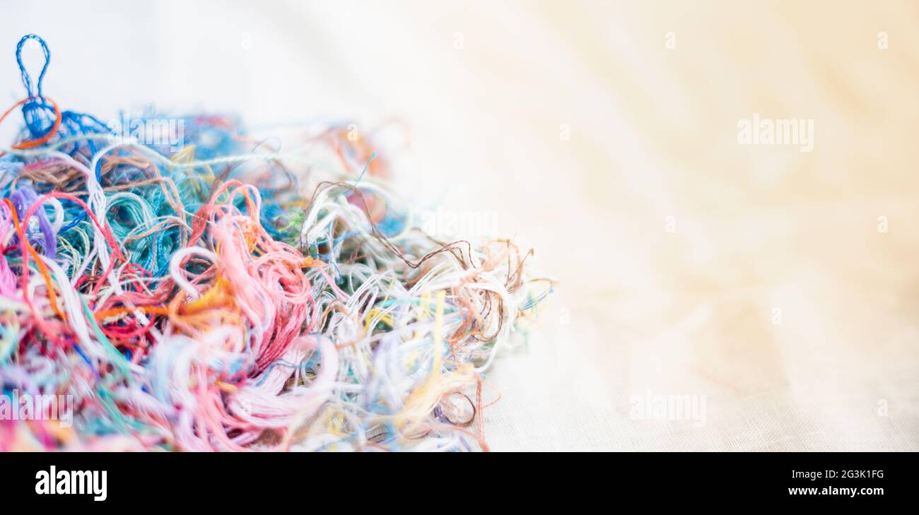 Selective focus with the pile of messy multicolor threads put on the ...