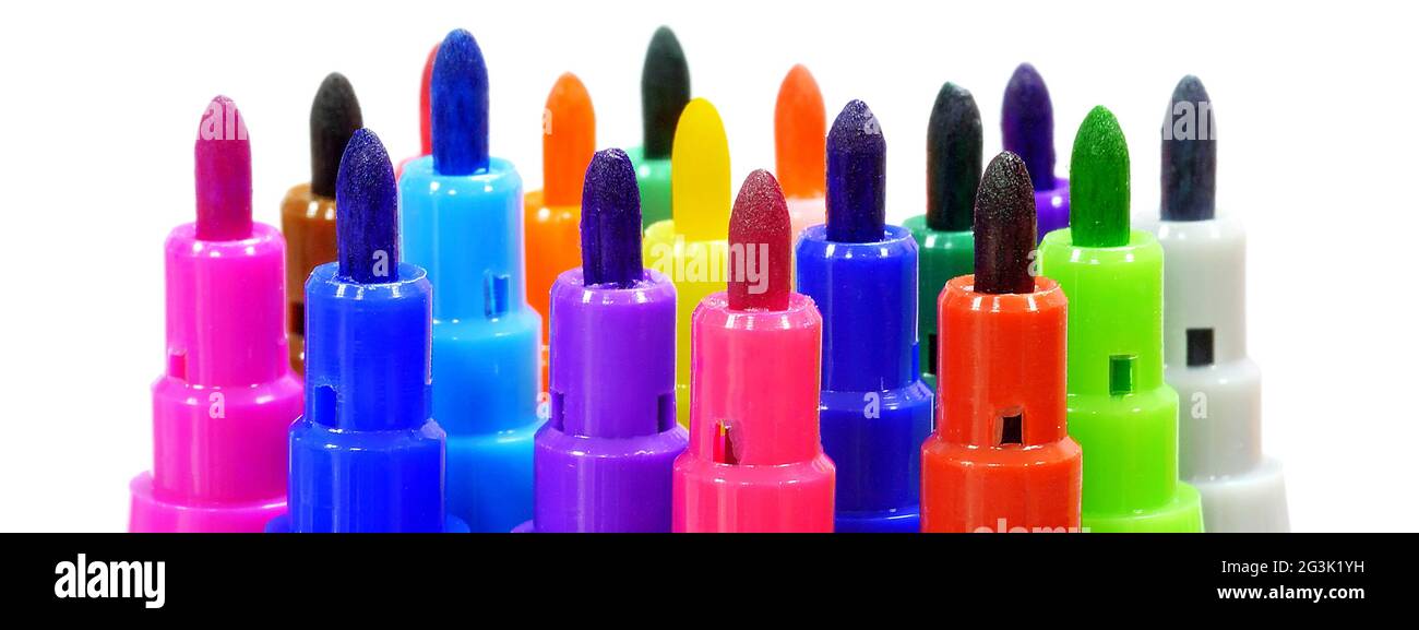 closeup on set of standing vertical colorful felt pens on white ...