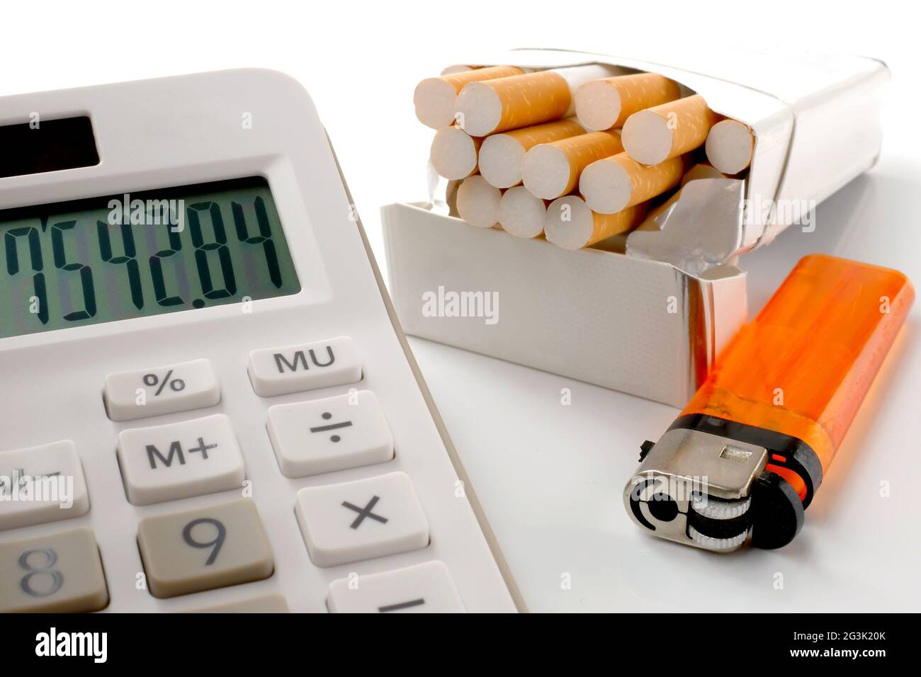 closeup on calculator with digits on display, cigarette pack and ...