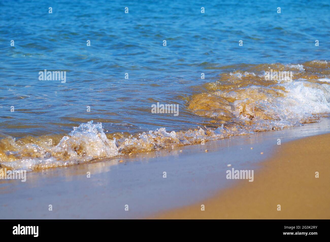 closeup of sea waves washing over sand on beach Stock Photo - Alamy