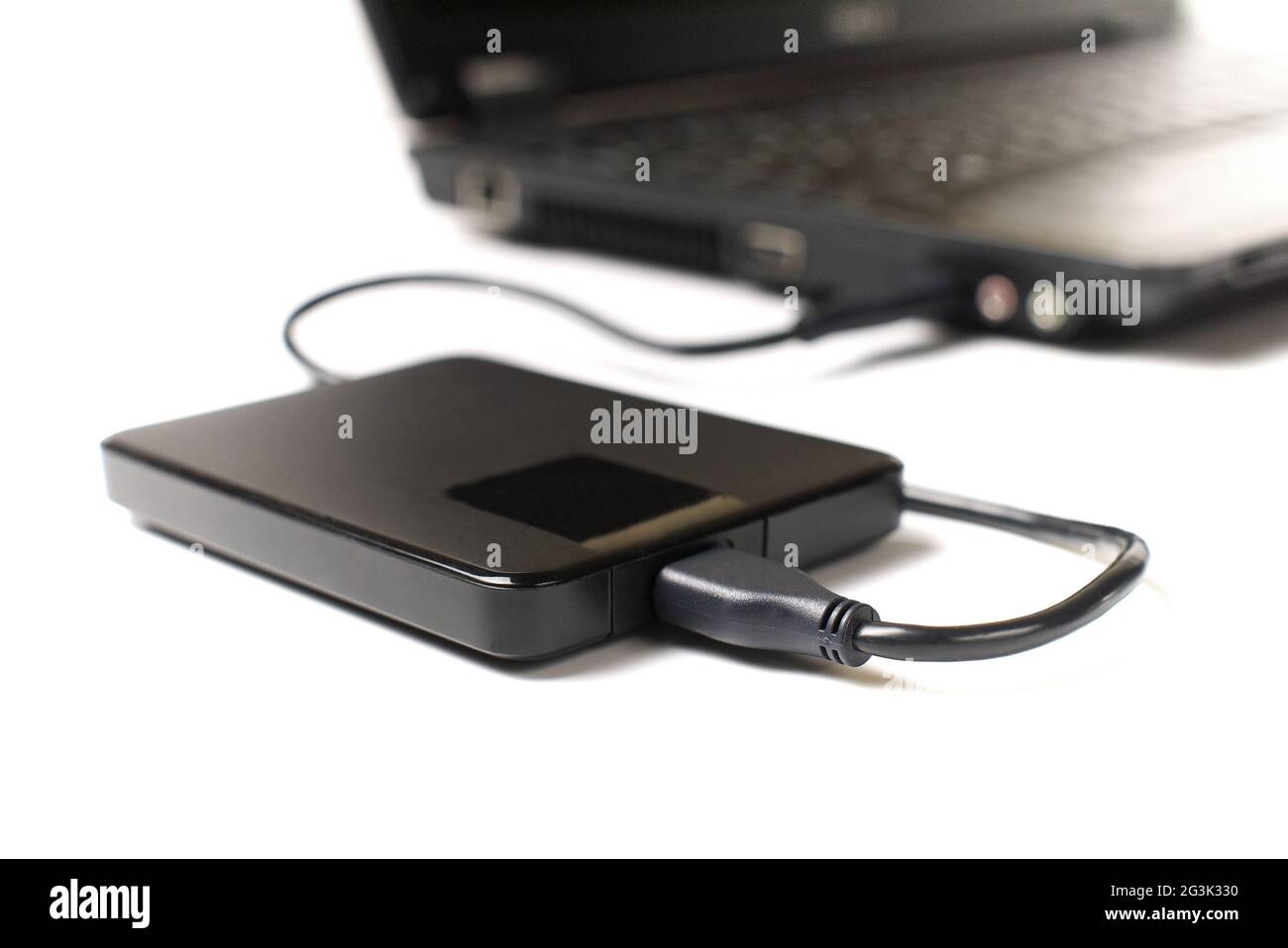 external usb disk connected to laptop on white background, shallow depth of field Stock Photo ...