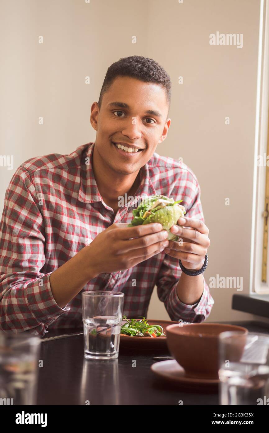 Young man eating tasty hi-res stock photography and images - Alamy