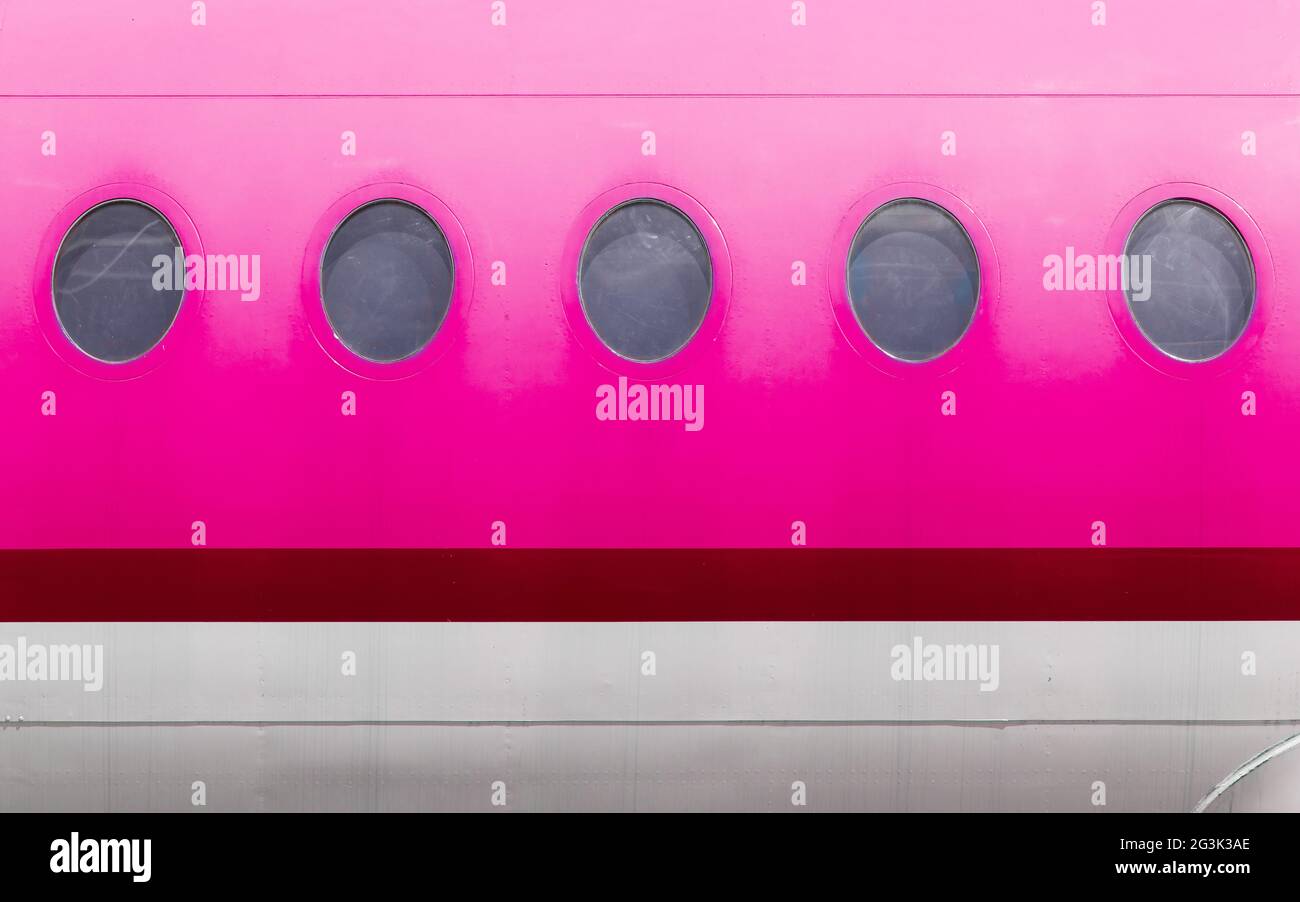 Windows of the pink airplane Stock Photo - Alamy