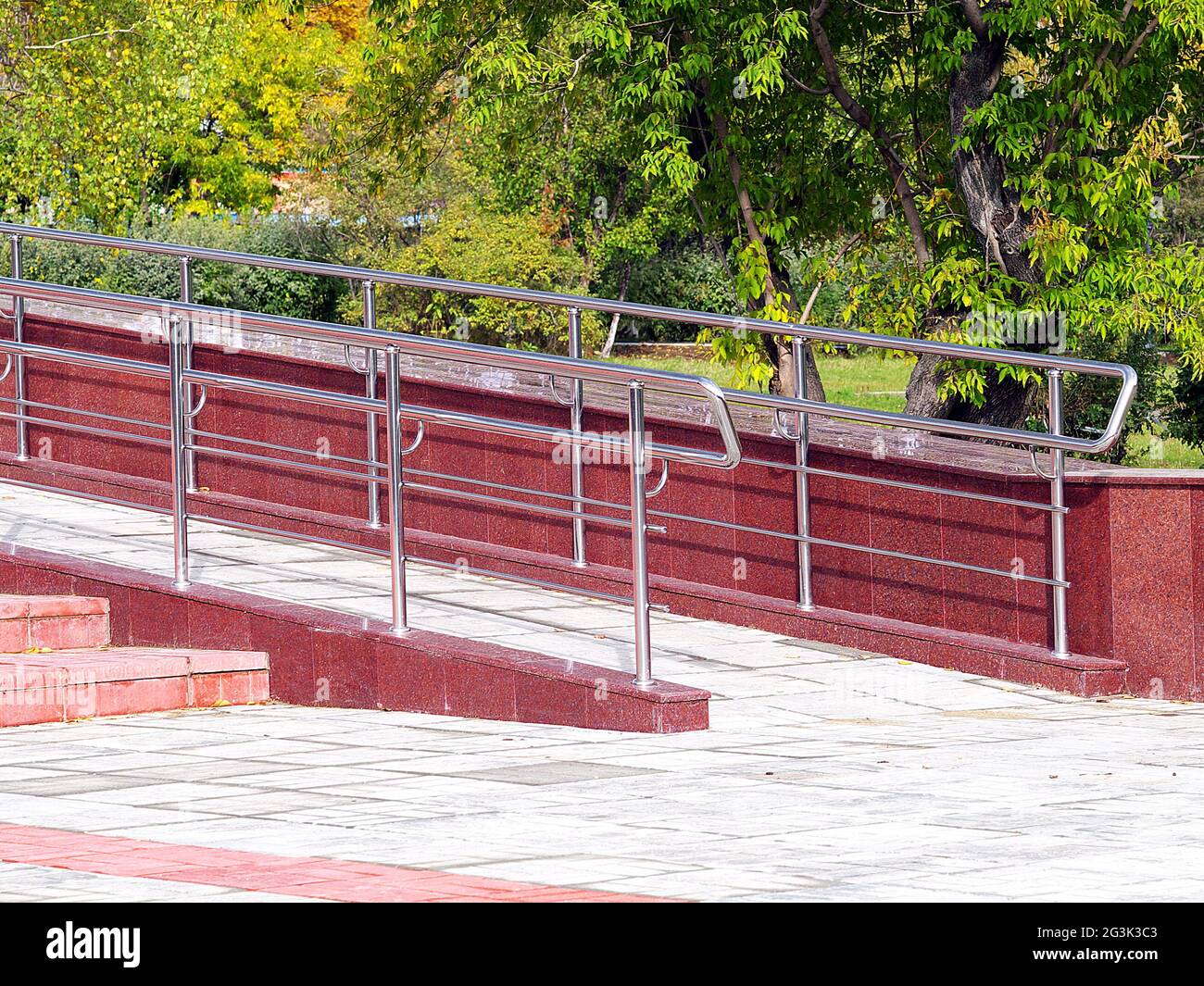 wheelchair ramp with metal handrails in city park Stock Photo - Alamy