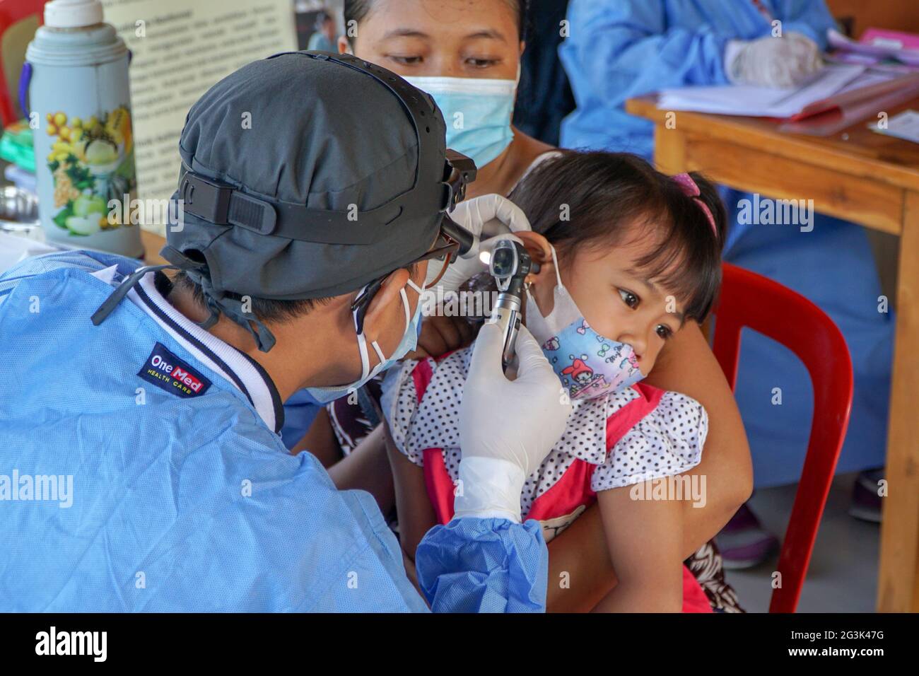 BALI/INDONESIA-MAY 28 2021: An ENT doctor is examining the ears, nose ...