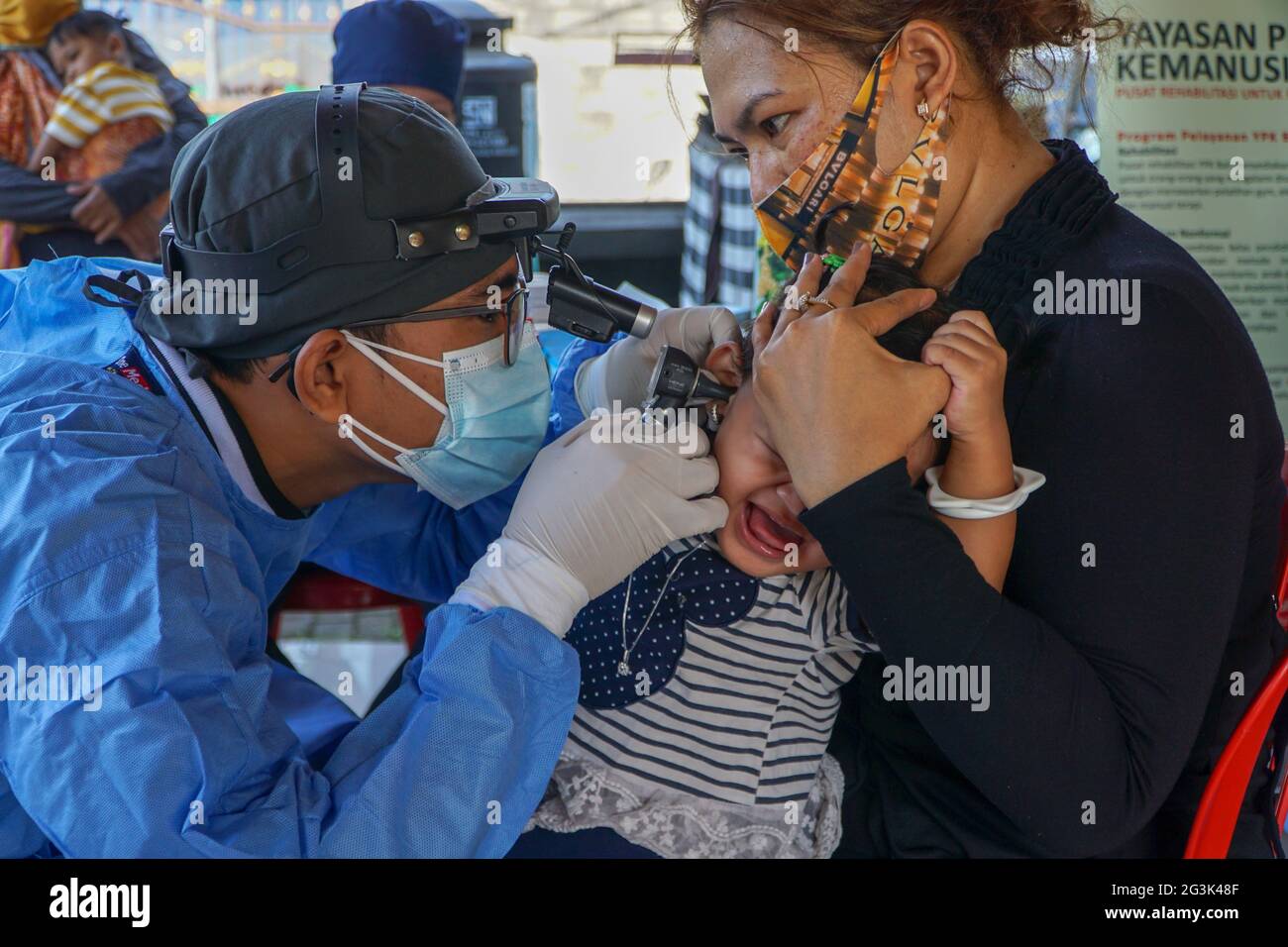 BALI/INDONESIA-MAY 28 2021: An ENT doctor is examining the ears, nose ...