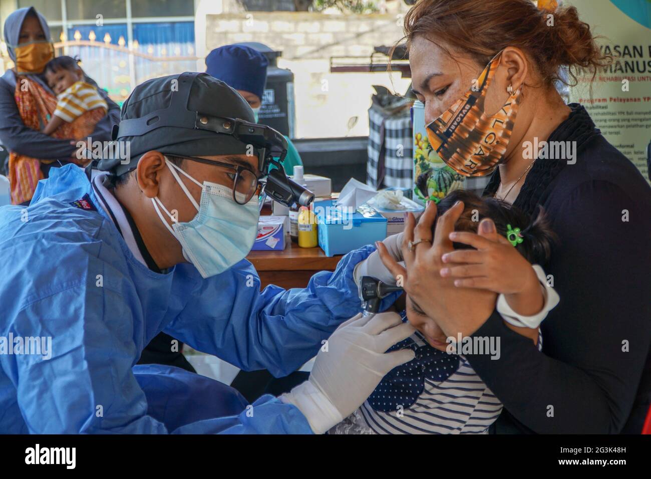 BALI/INDONESIA-MAY 28 2021: An ENT doctor is examining the ears, nose ...
